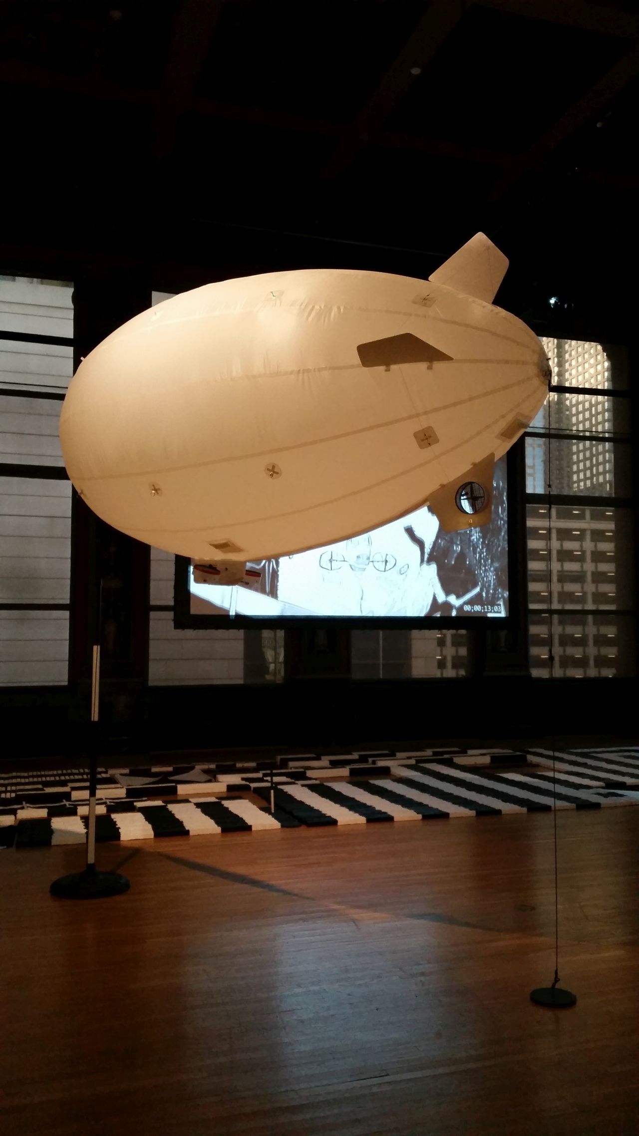 A Blimp Floats in a Gallery, Imagining the View from Space